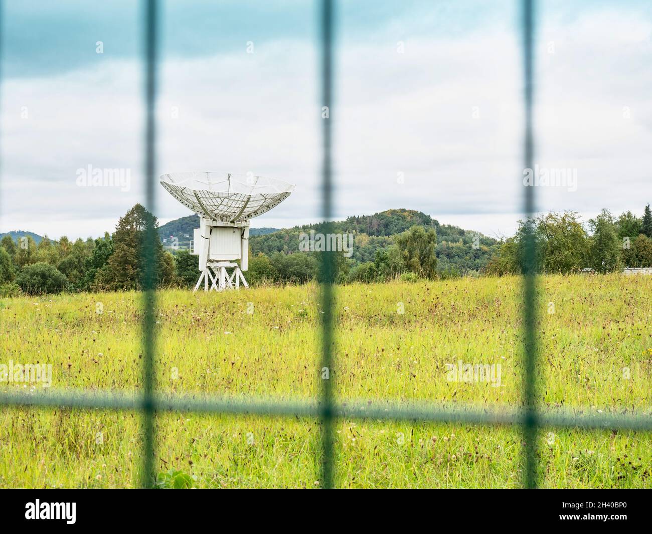 Microwave communication dish behind the fence in secure area. Large ...