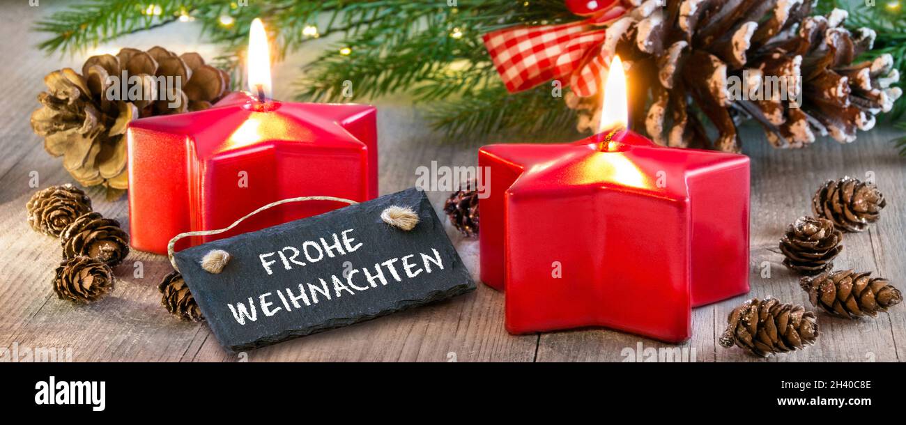 German Merry Christmas label and red decoration with candles and fir ...
