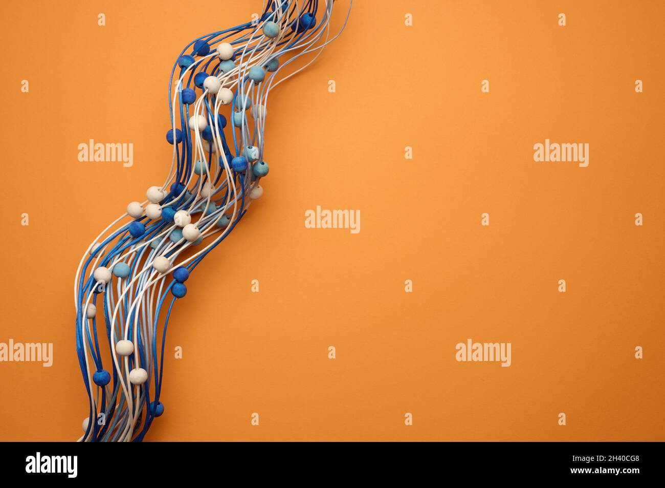 Orange background with wooden blue decor branch. Backdrop for product ...