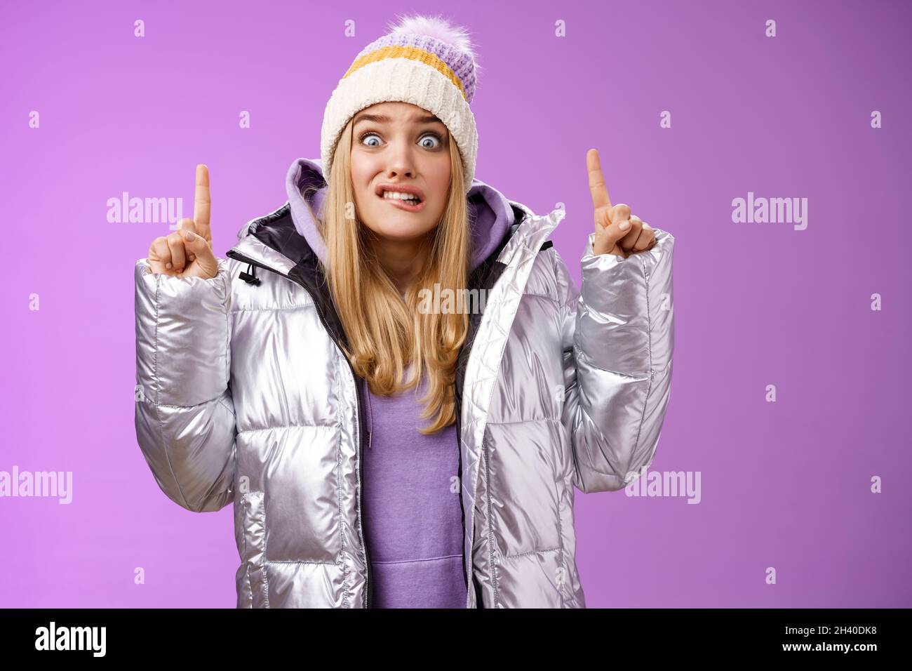 Scared unsure worried awkward young cute blond girl biting lip stooping ...