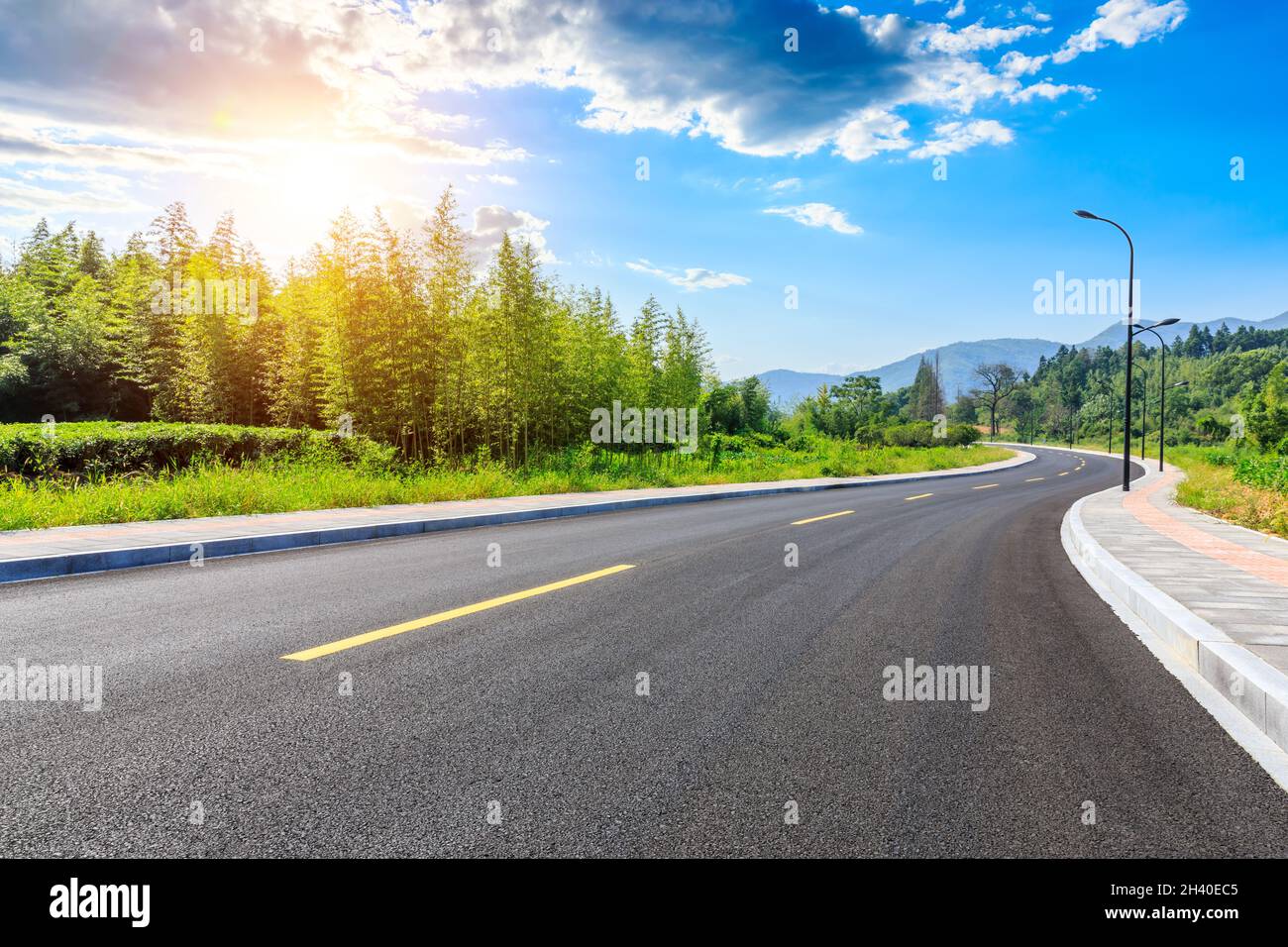 Countryside asphalt road and green plants with mountain natural scenery ...