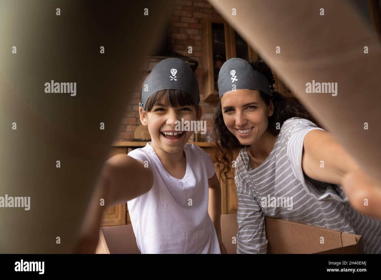 Happy funny mom and daughter kid playing pirates at home Stock Photo ...