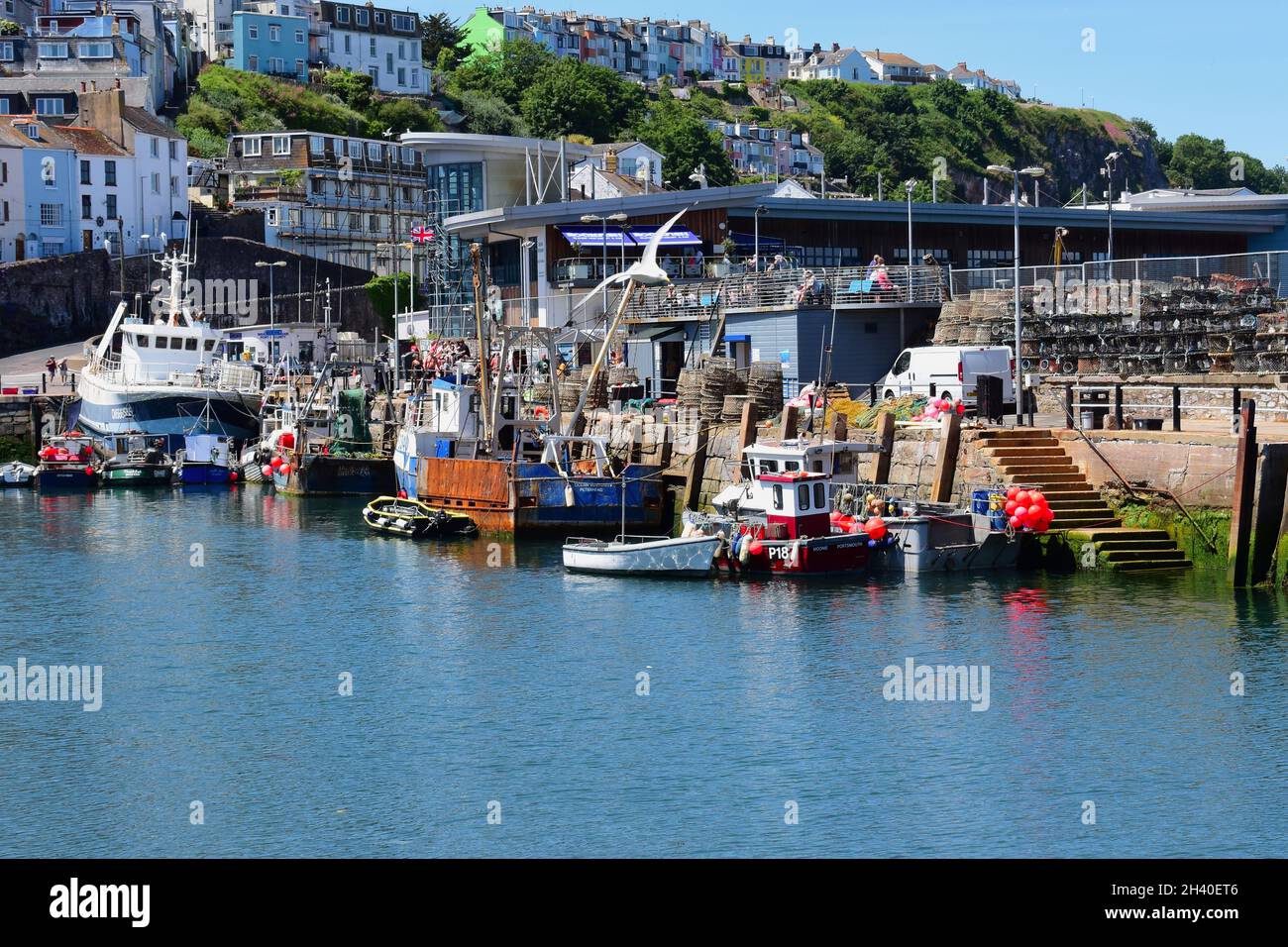 A scene of local trawlers tied up at the harbour in Brixham adjacent to ...