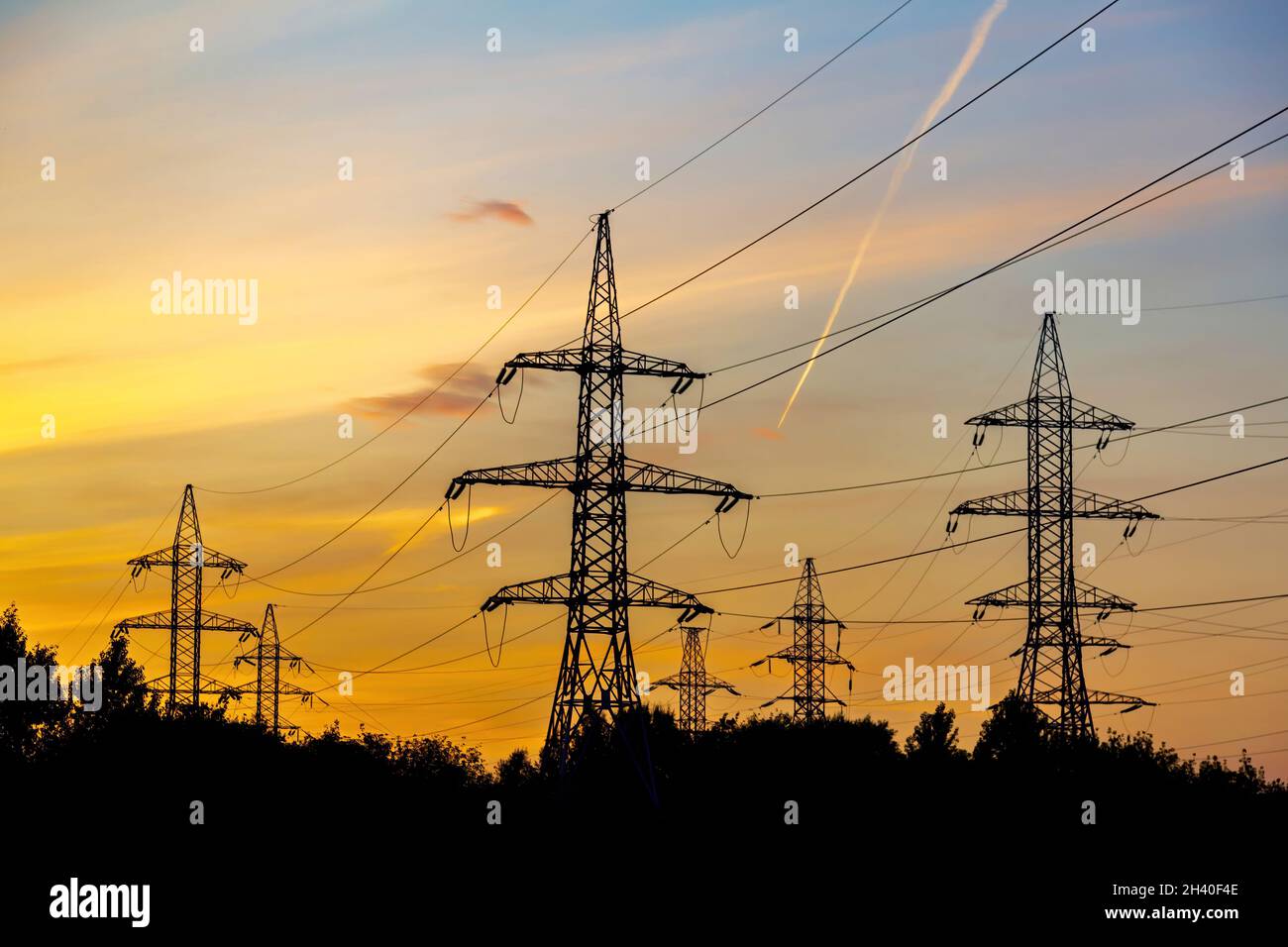 Line of high voltage wires during scenic sunset Stock Photo - Alamy