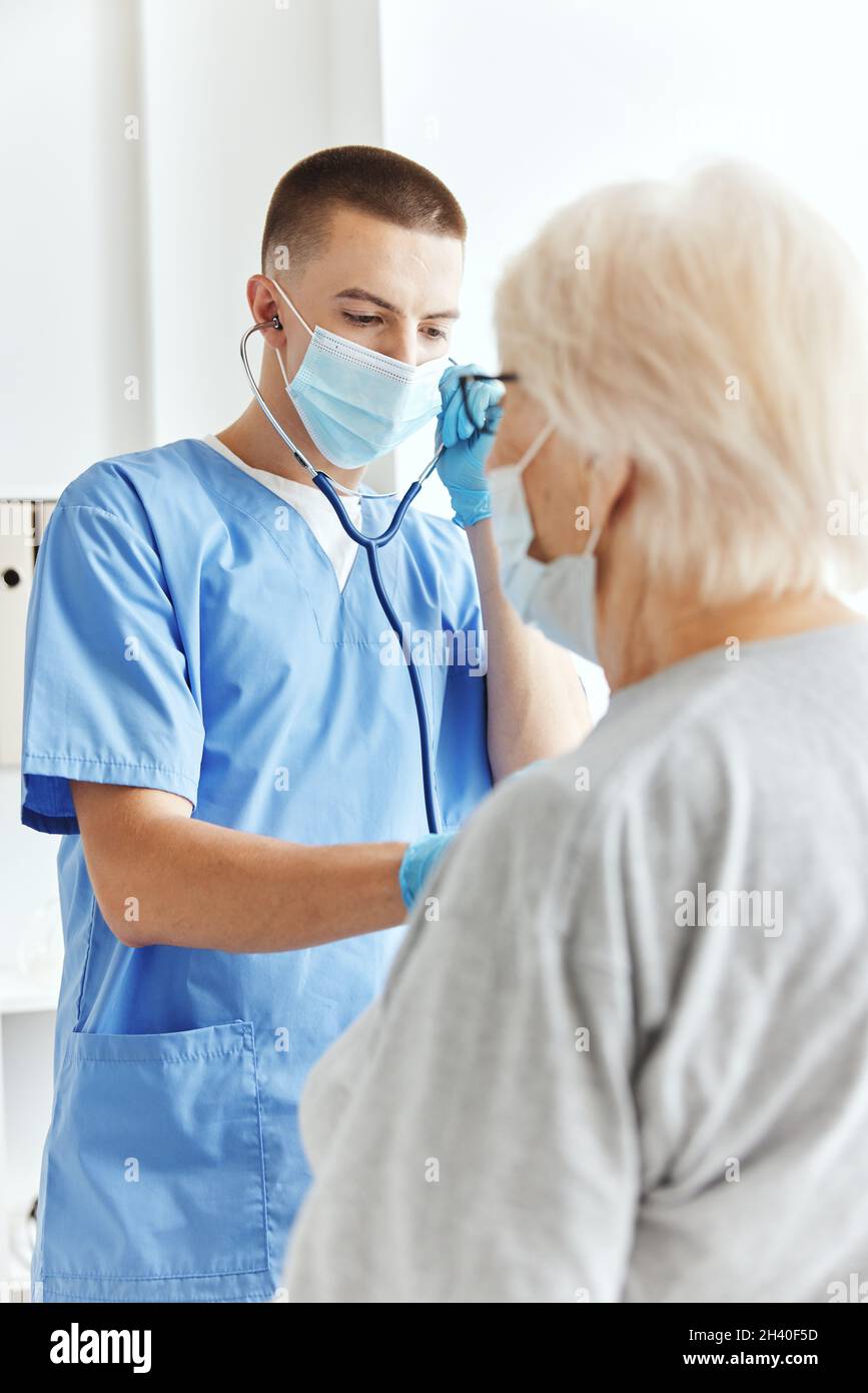 Medical worker examine sick mature hi-res stock photography and images ...