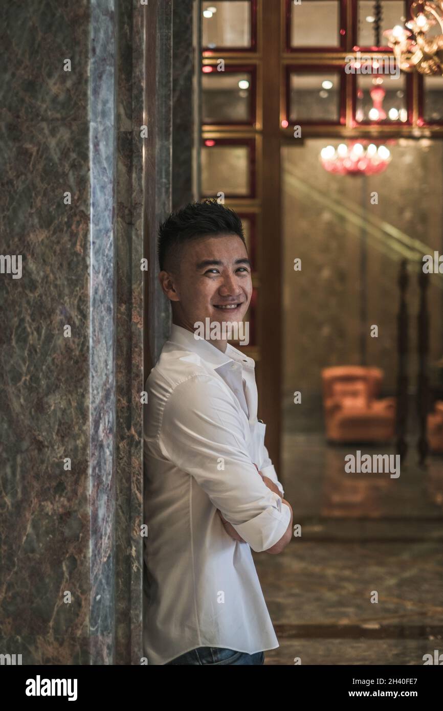 Portrait of asian young handsome man in white casual shirt standing ...