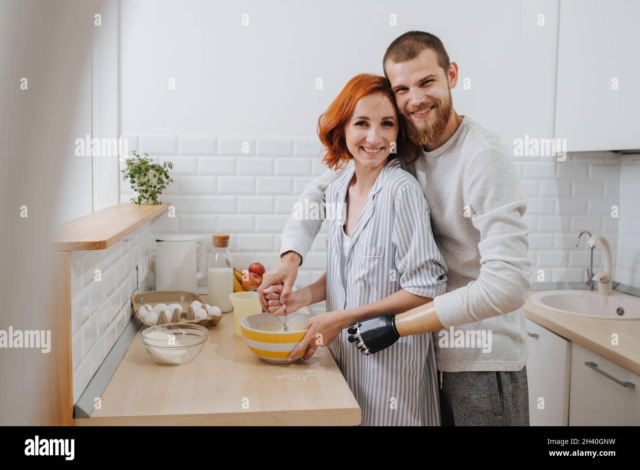 Portrait of a thirty year old couple cooking together in the kitchen ...
