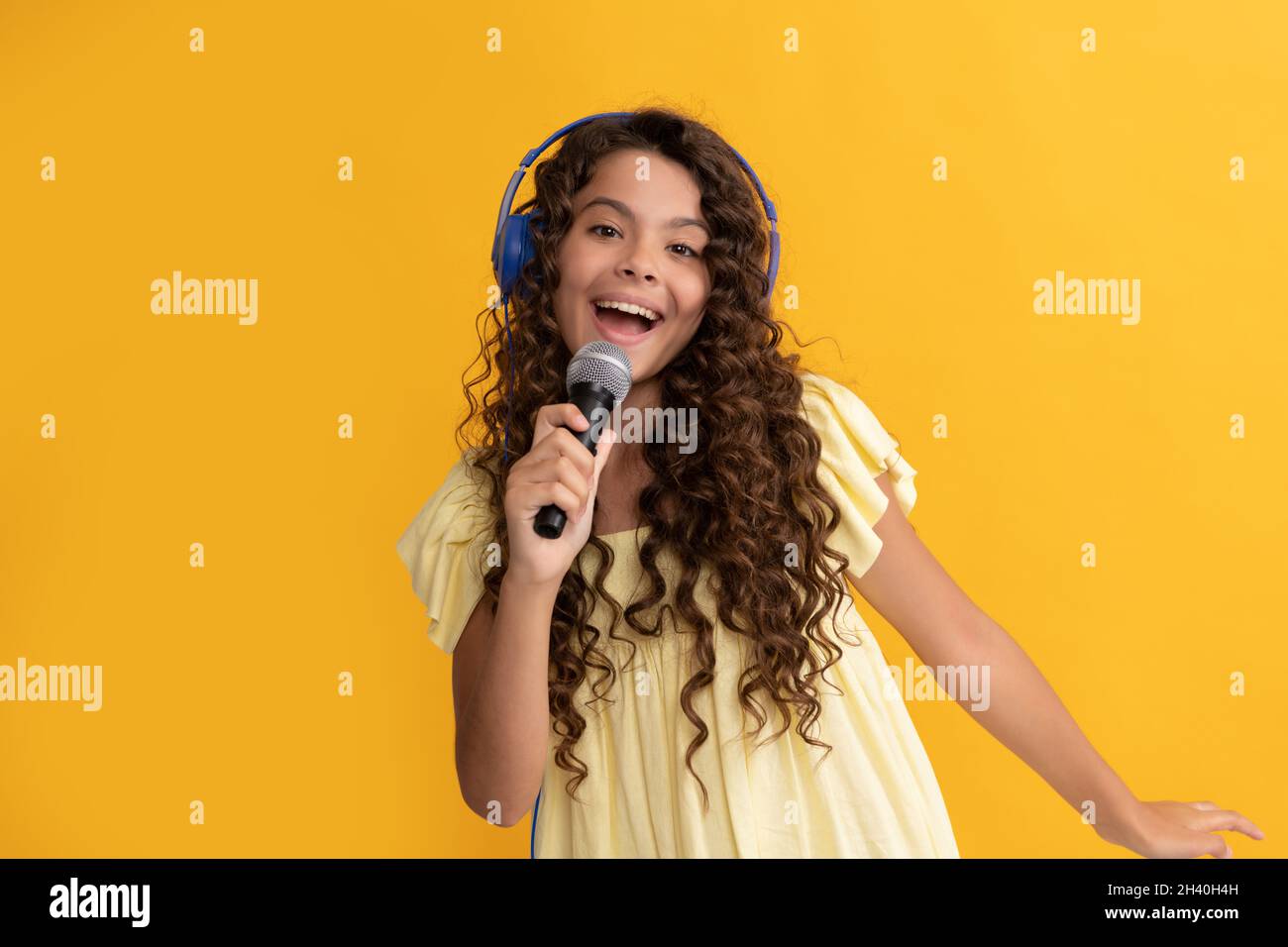 child singer sing karaoke in microphone. online vocal education. back ...