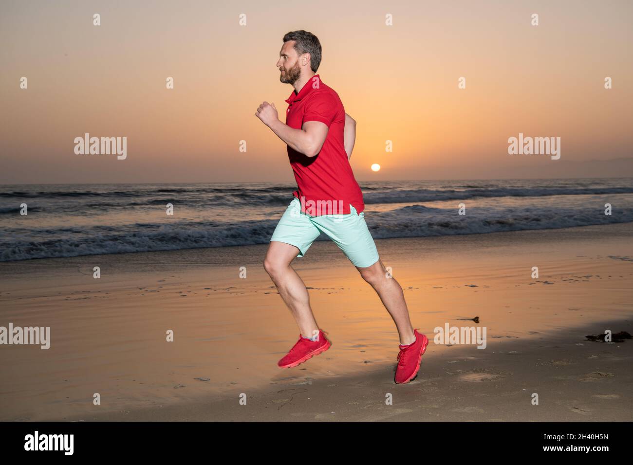 athletic man runner running on sunset summer beach, athlete Stock Photo ...