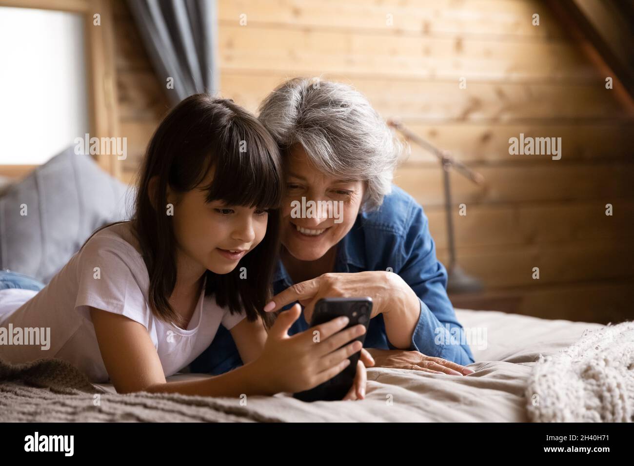 Happy generation Z girl and mature senior 60s grandma Stock Photo - Alamy