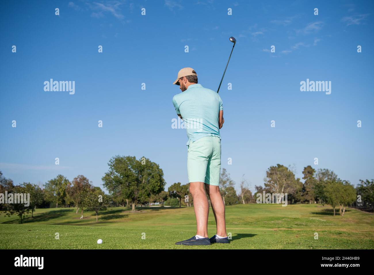 male golf player on professional golf course. portrait of golfer in cap ...