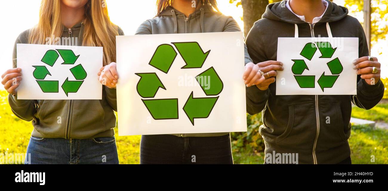 Wide view of team of environmental protection volunteers holding ...
