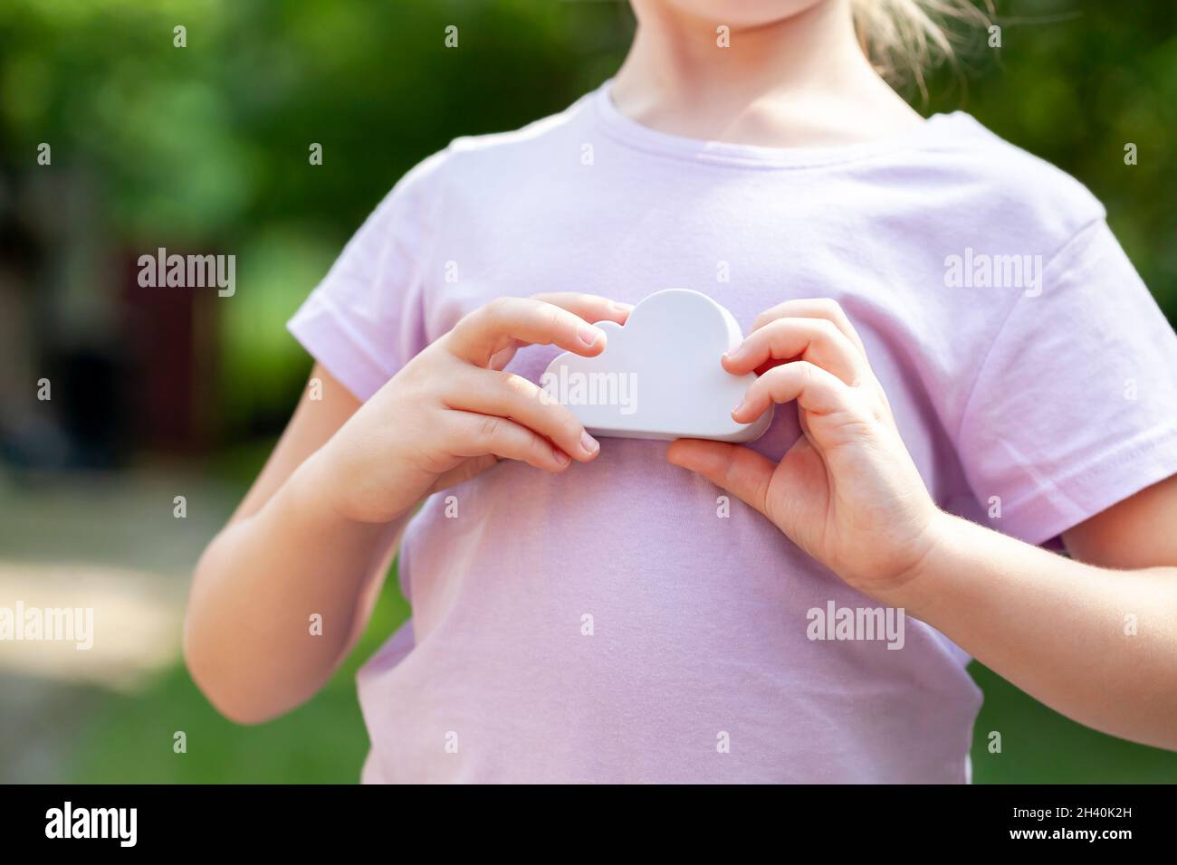 Young anonymous child, elementary school age girl holding a simple ...