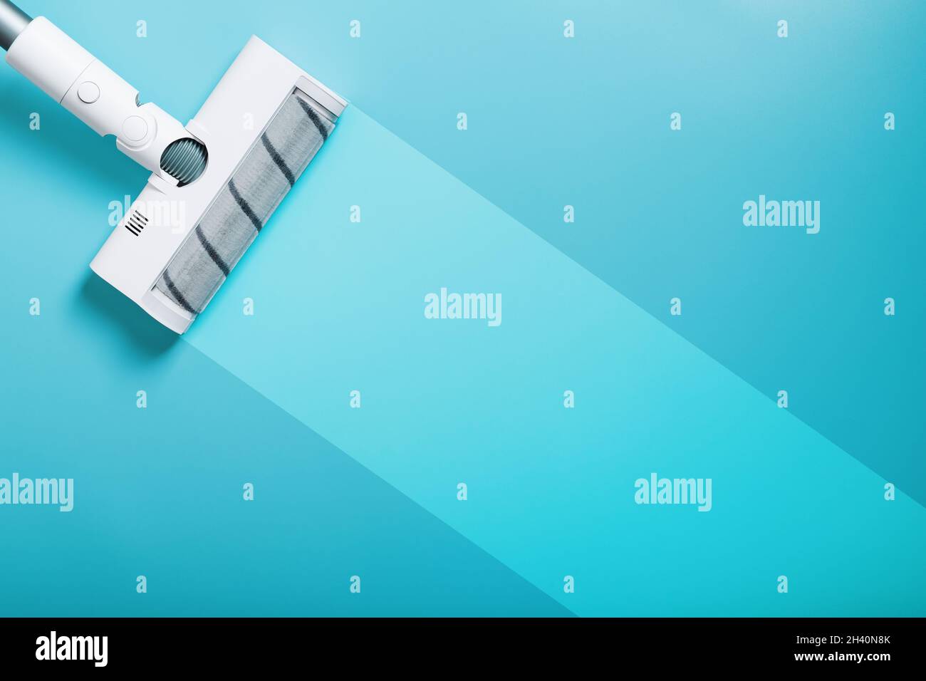 A vacuum cleaner nozzle with a clean stripe on a blue background. Free ...