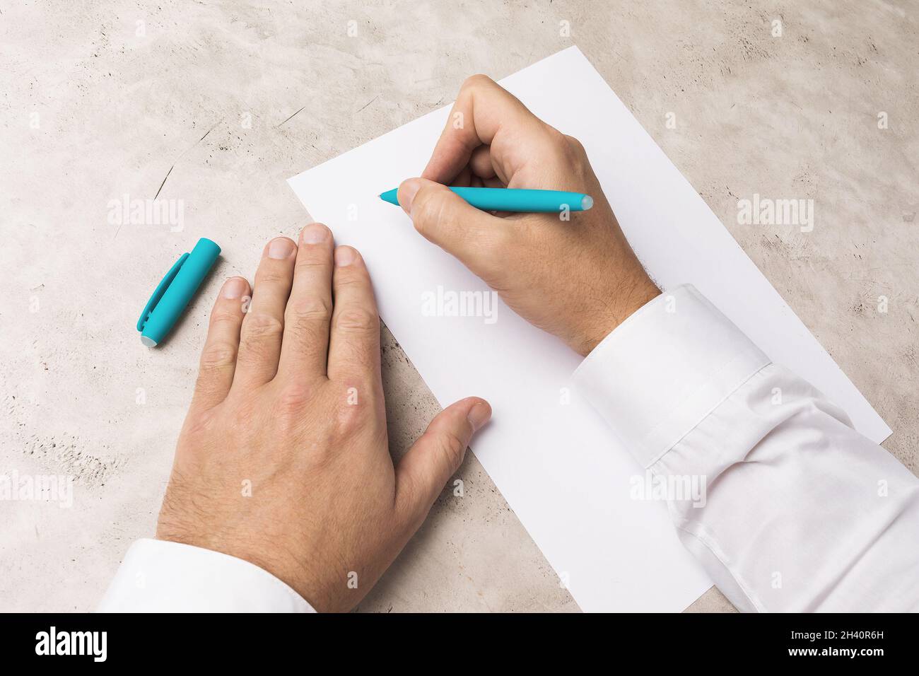 A sheet of paper and a ballpoint pen in hand, the concept of writing ...