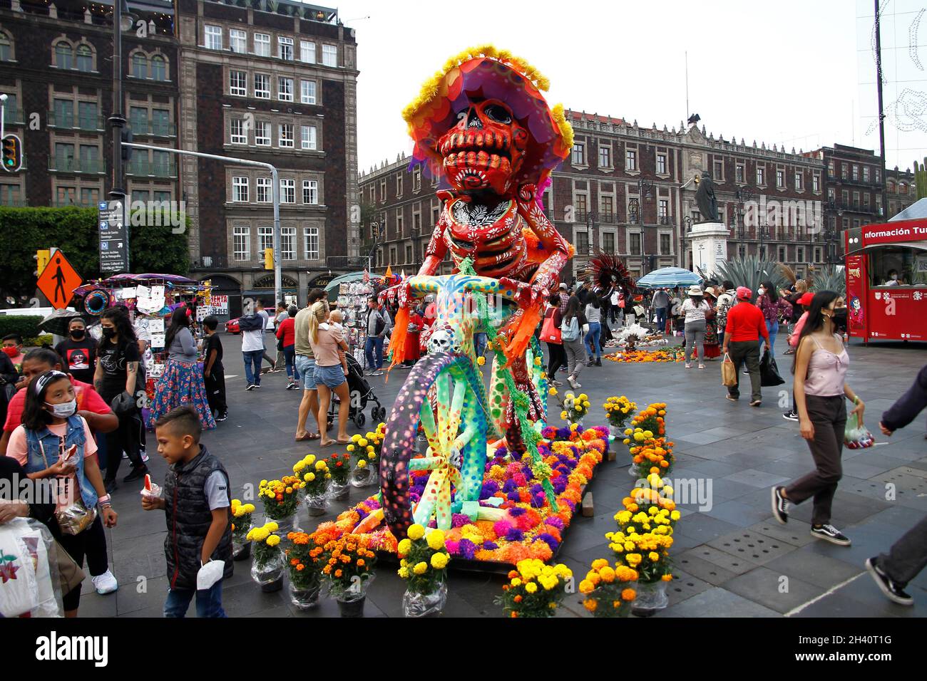 Non Exclusive: A woman takes a photo of her dog in front a Catrina ...