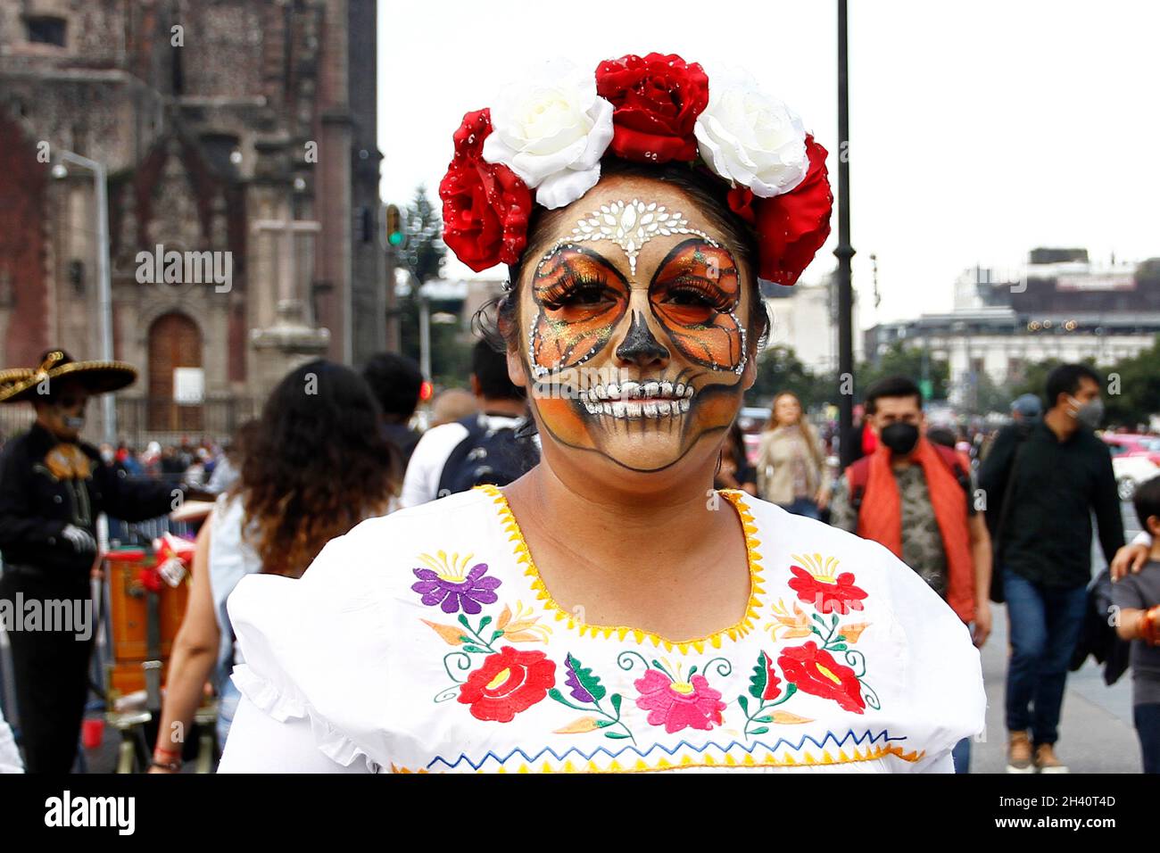 Non Exclusive: A woman takes a photo of her dog in front a Catrina ...