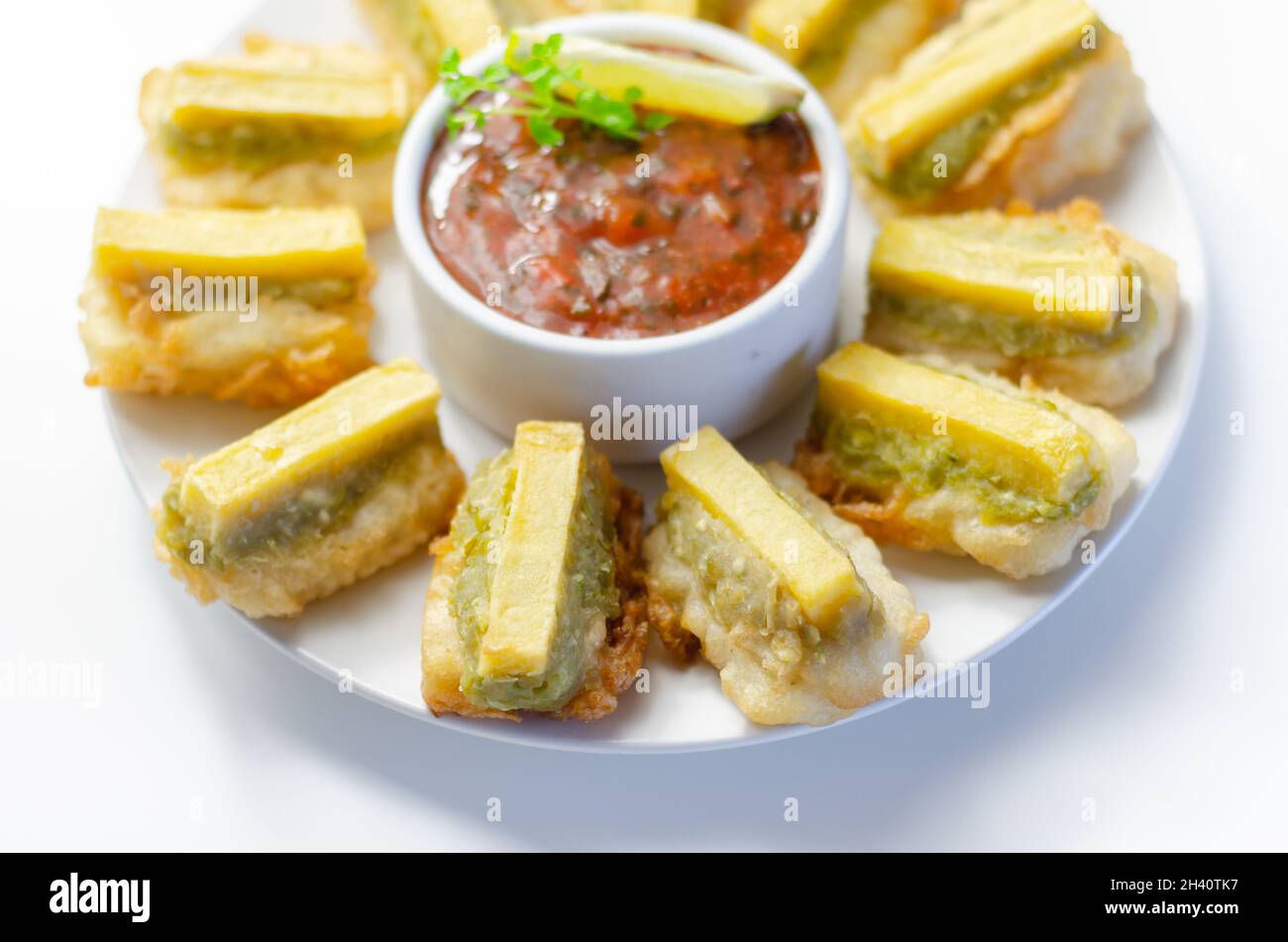 Skinless and boneless battered Alaska Pollock fillet pieces, topped ...
