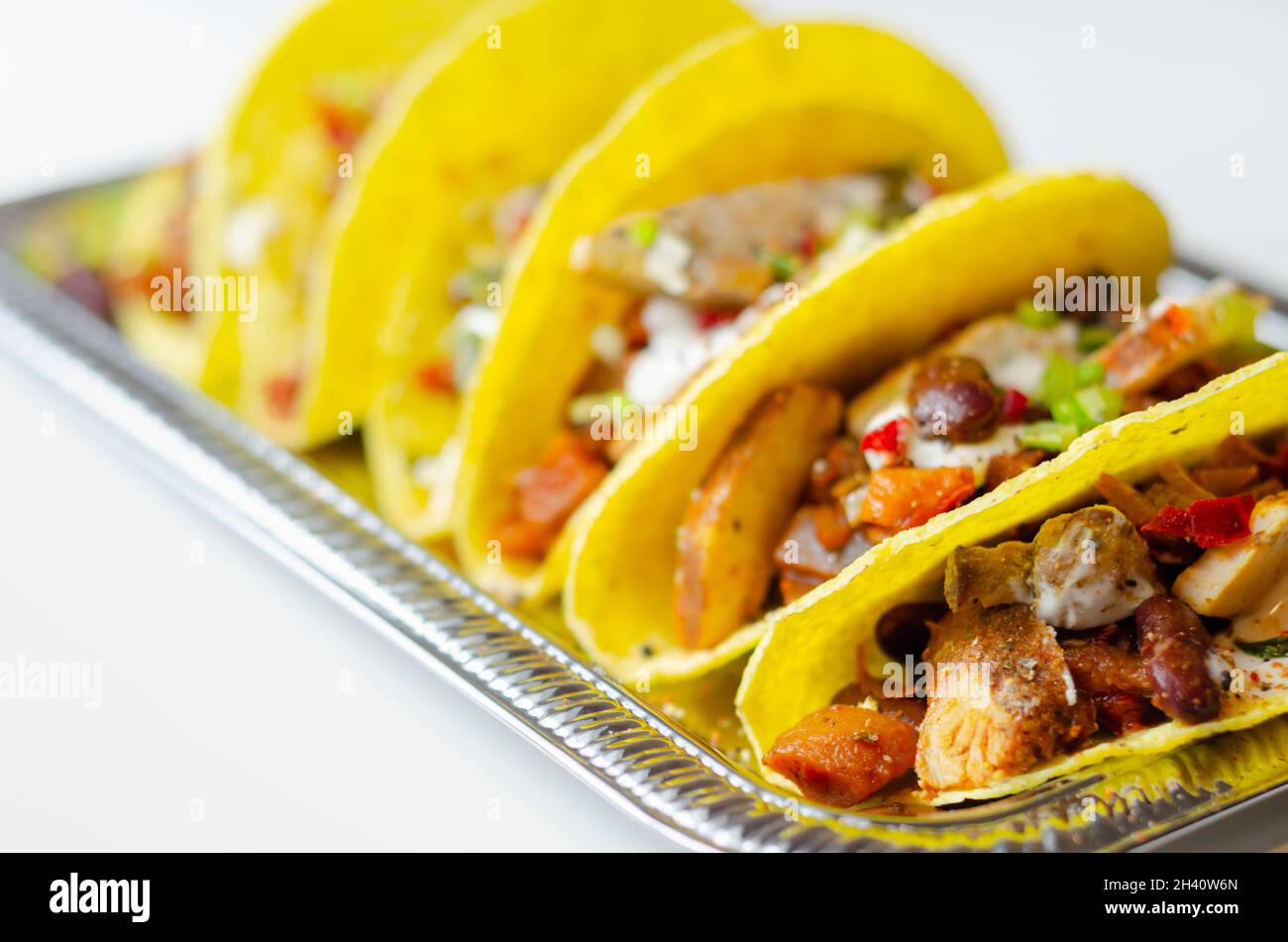 Mexican tacos shells with chicken and red kidney beans, onion, red and ...