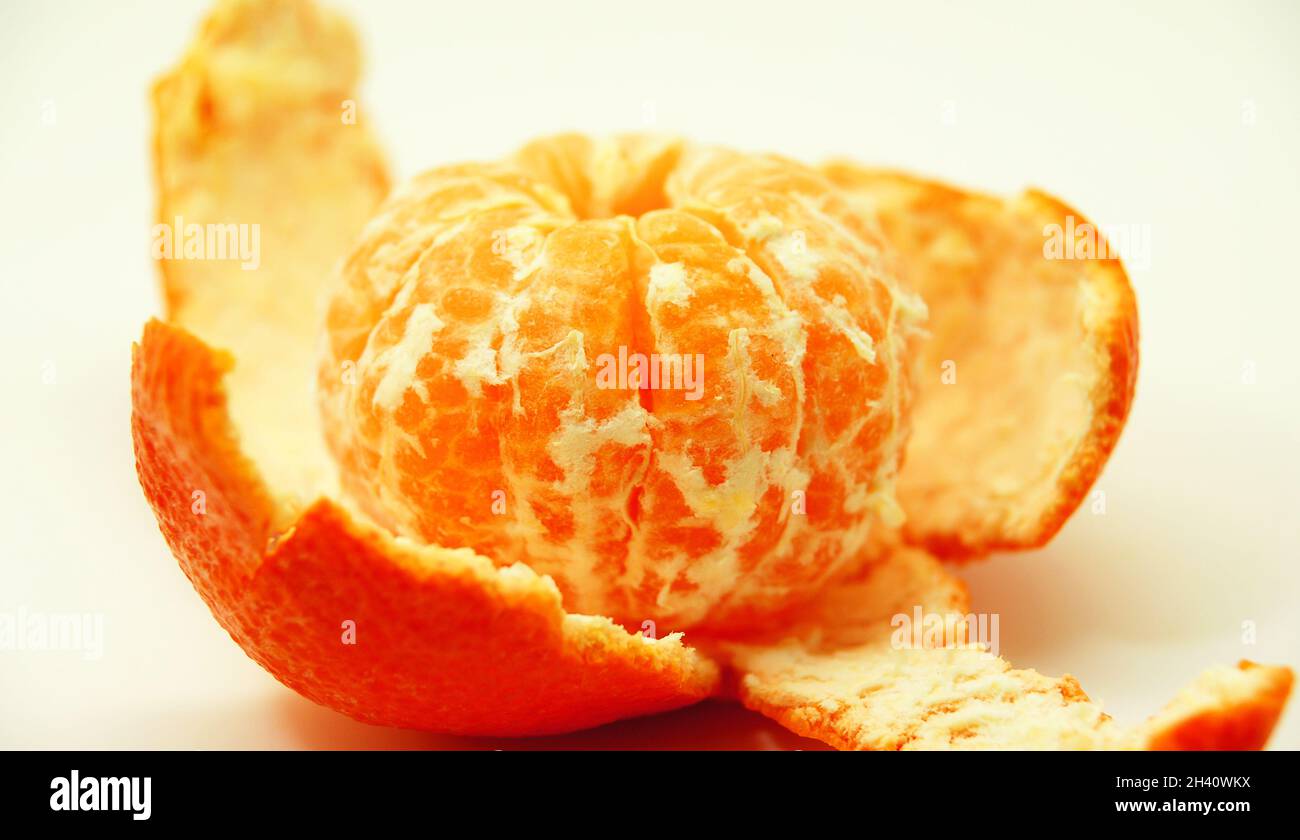 Tangerine on its skin with white background Stock Photo - Alamy