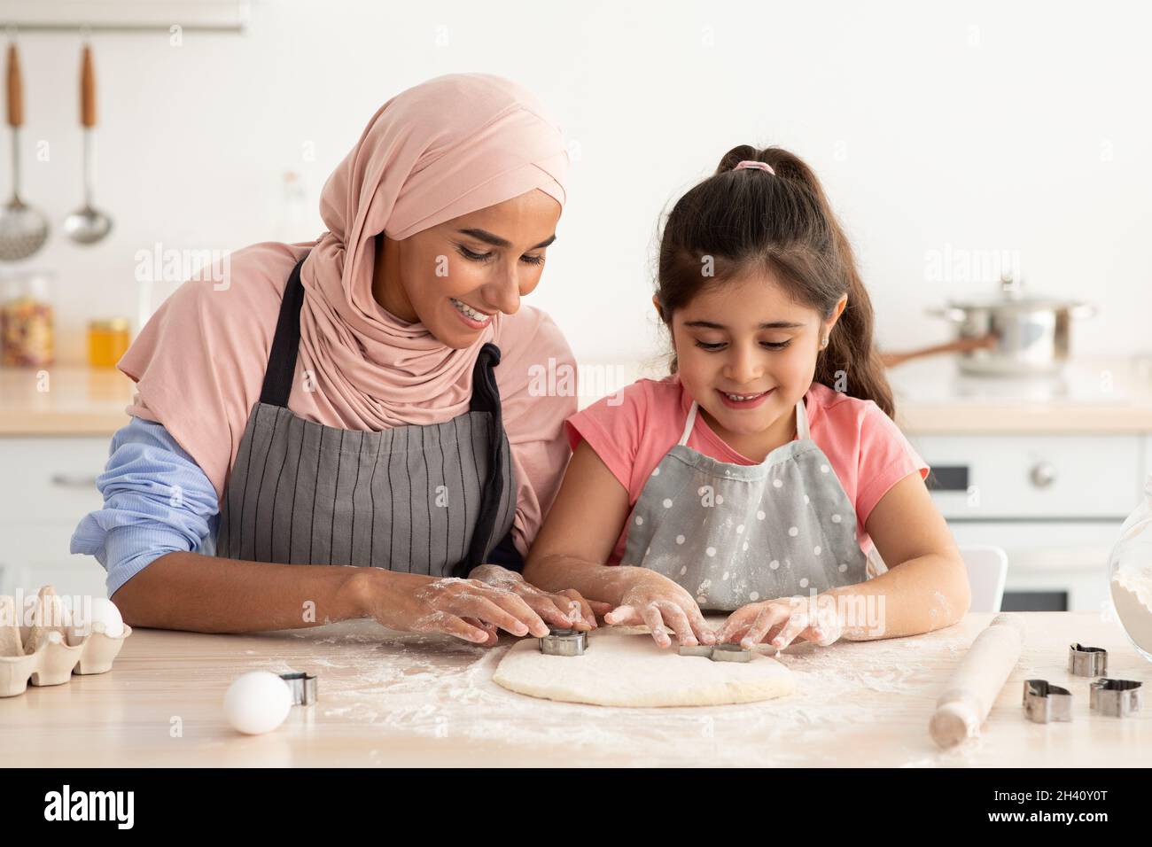 Cheerful Muslim Mother In Hijab Baking With Her Little Daughter In ...