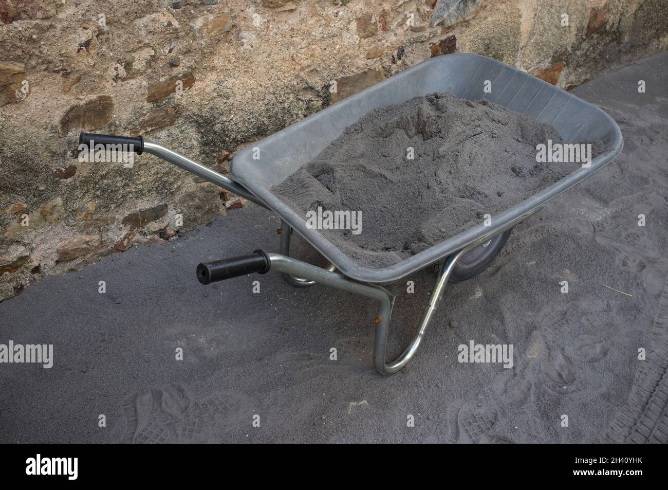 Wheelbarrow loading black topsoil. Construction industry tool Stock ...