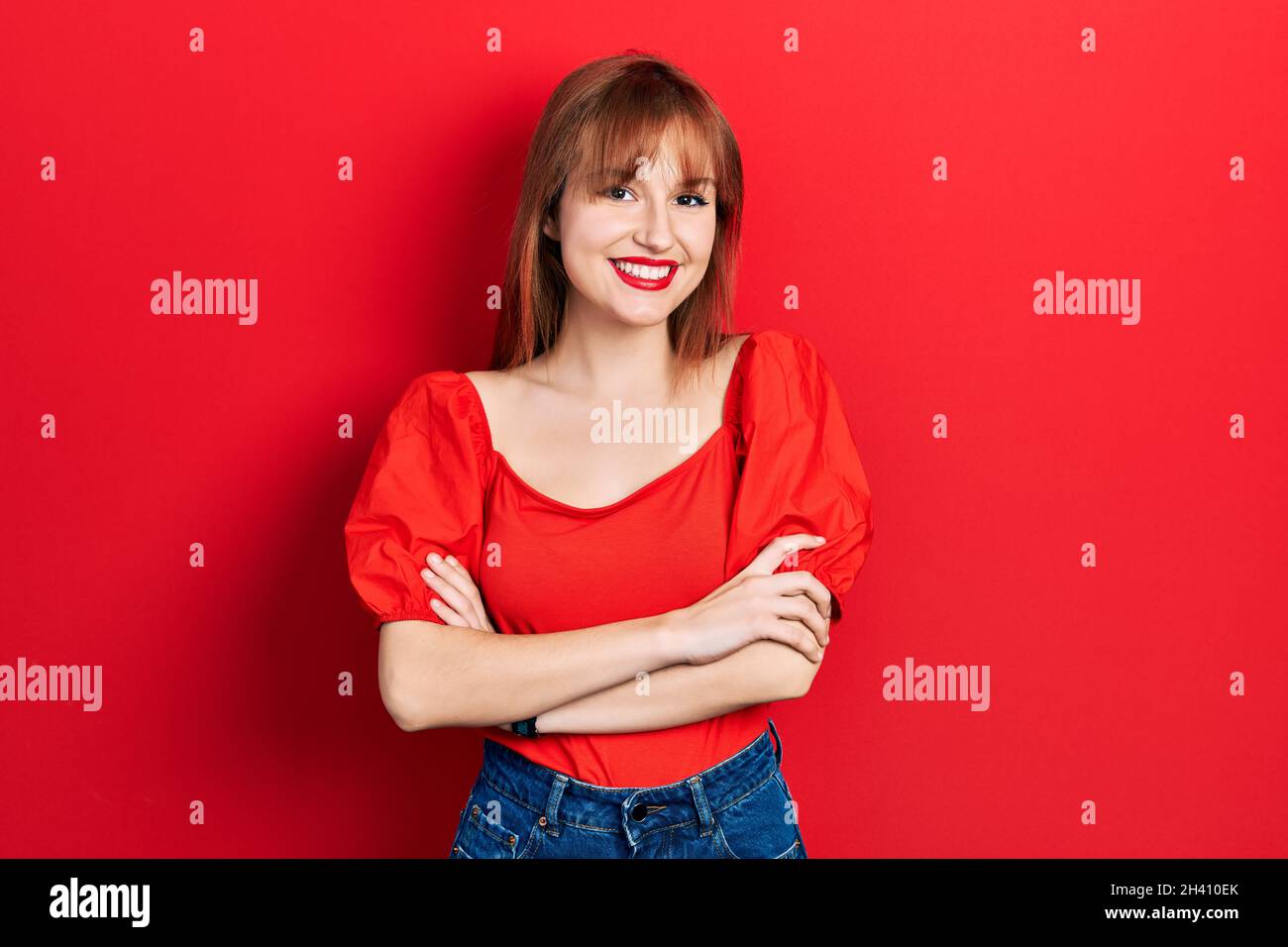 Redhead young woman wearing casual red t shirt happy face smiling with ...