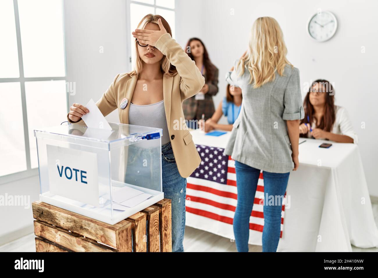 Group of young girls voting at democracy referendum covering eyes with ...