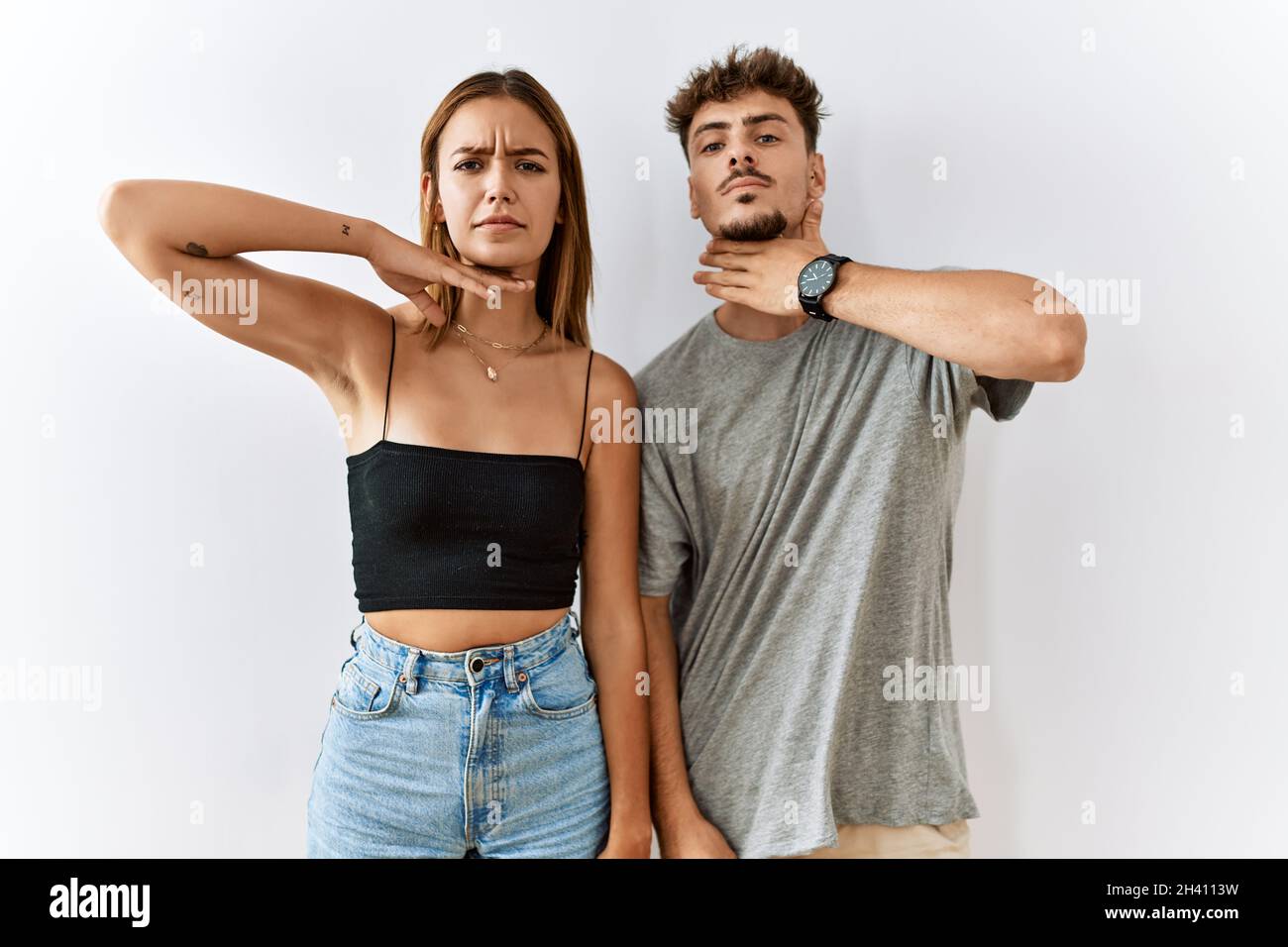 Young beautiful couple standing together over isolated background ...