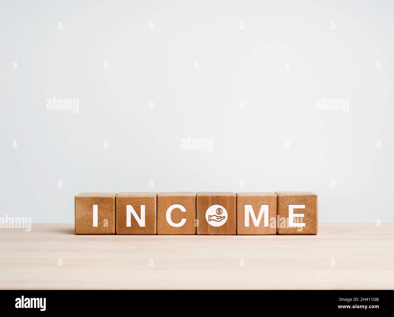 Words "INCOME" with saving money icon symbol on wooden cube blocks on ...