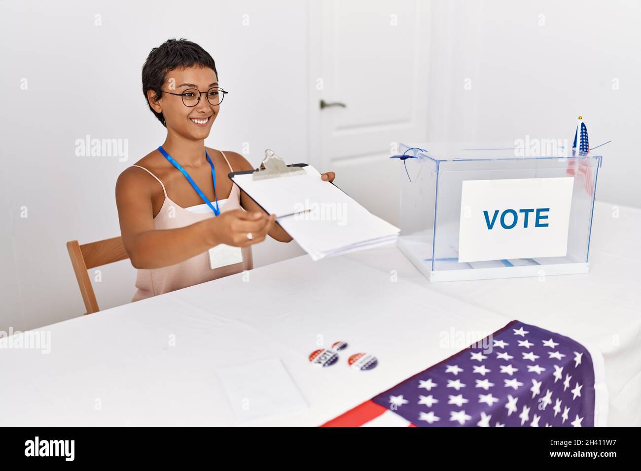 Young hispanic woman smiling confident holding checklist working at ...