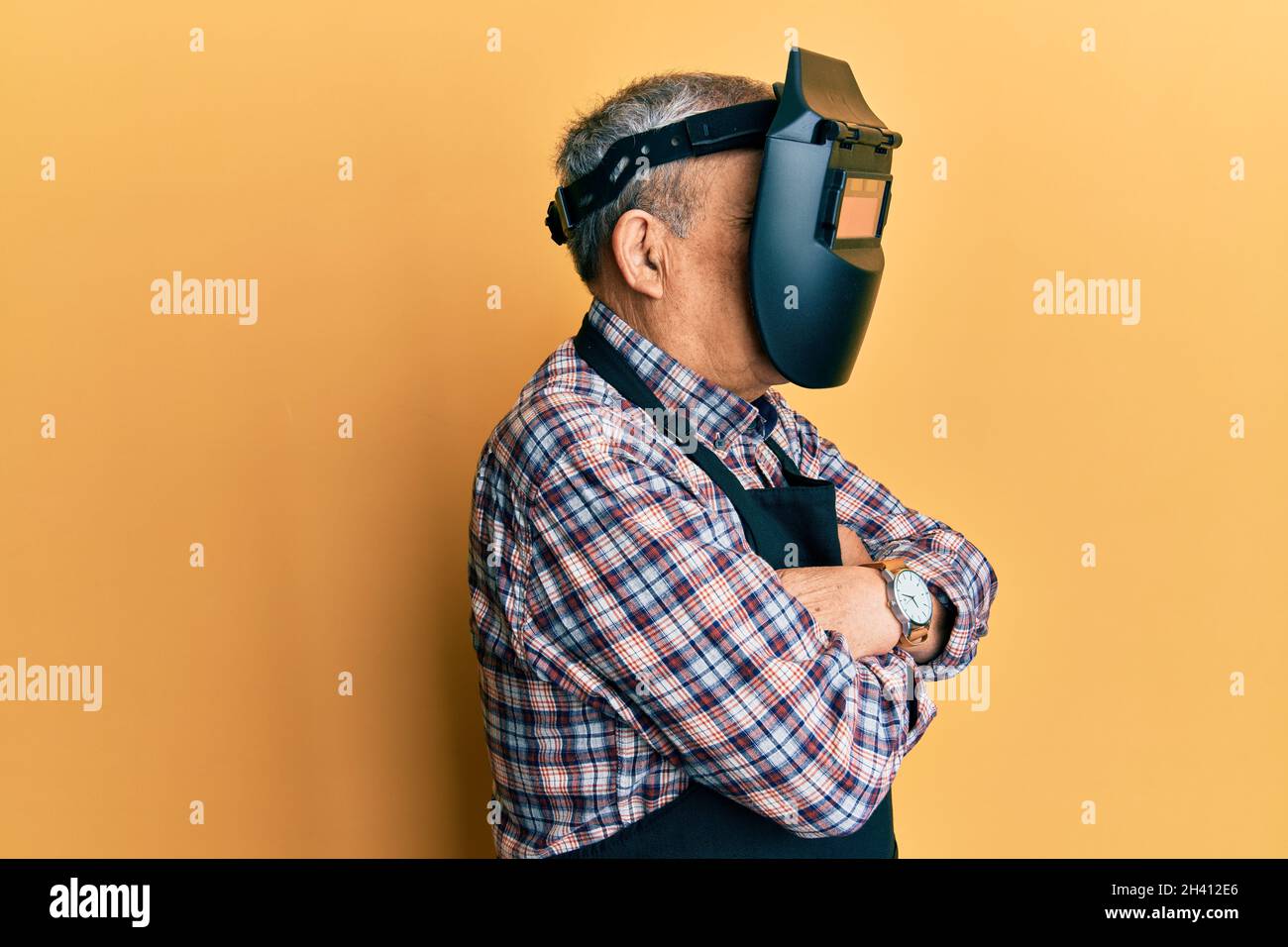 Repair man wearing professional welding mask over head covering face ...