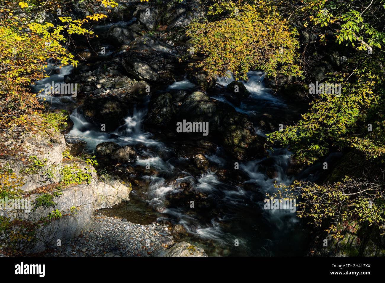 Autumn colours and river.Slow shutter image of Tama river in the ...