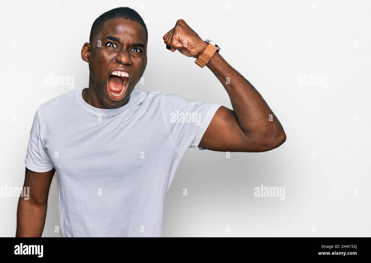 Young african american man wearing casual white t shirt angry and mad ...