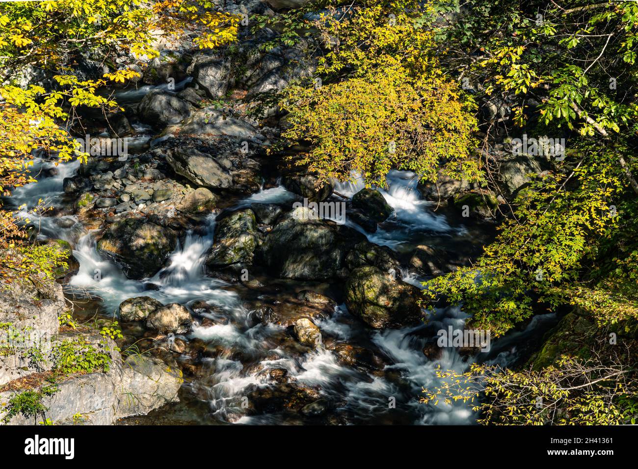 Autumn colours and river.Slow shutter image of Tama river in the ...