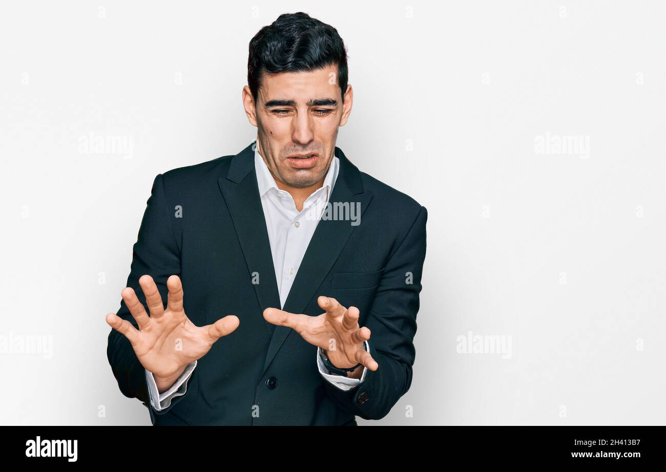 Handsome hispanic man wearing business clothes disgusted expression ...