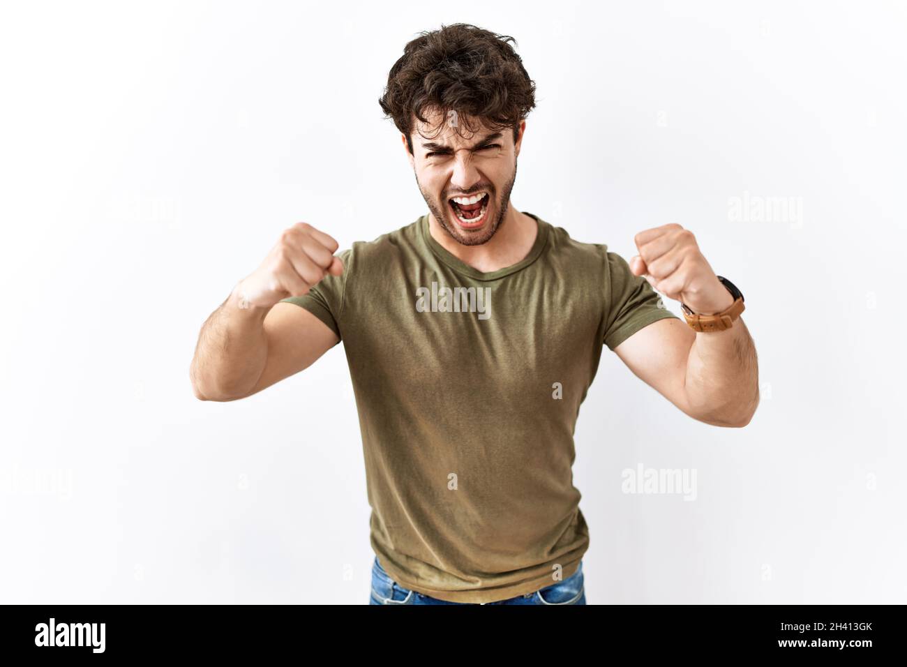 Hispanic man standing over isolated white background angry and mad ...
