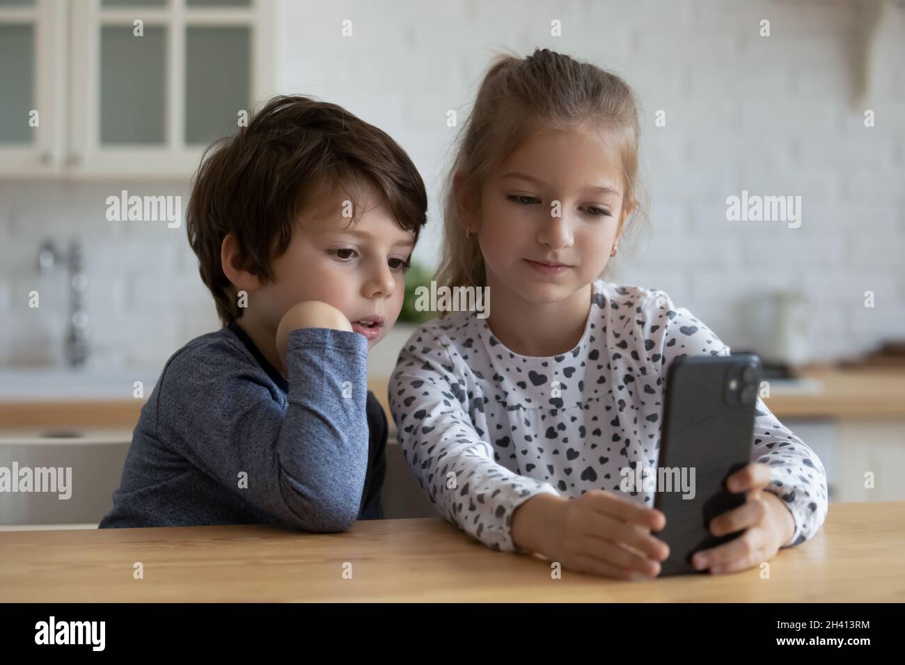 Happy adorable little kids playing cellphone at home Stock Photo - Alamy