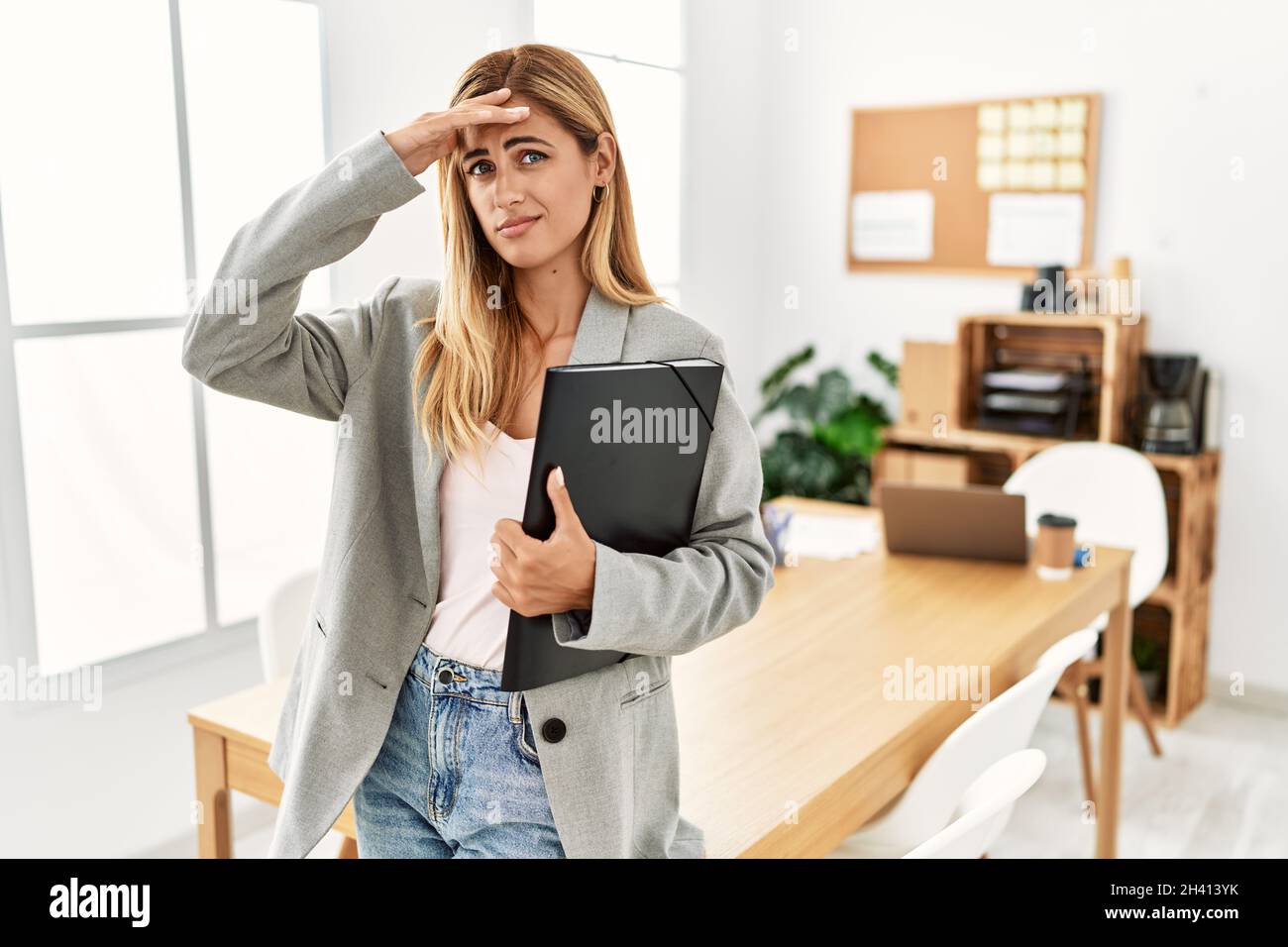 Blonde business woman at the office worried and stressed about a ...