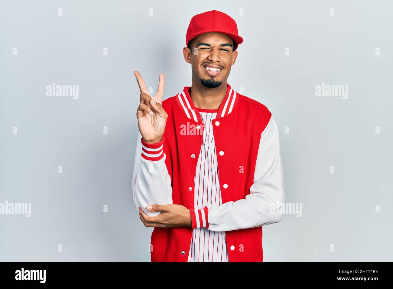 Young african american man wearing baseball uniform smiling with happy ...