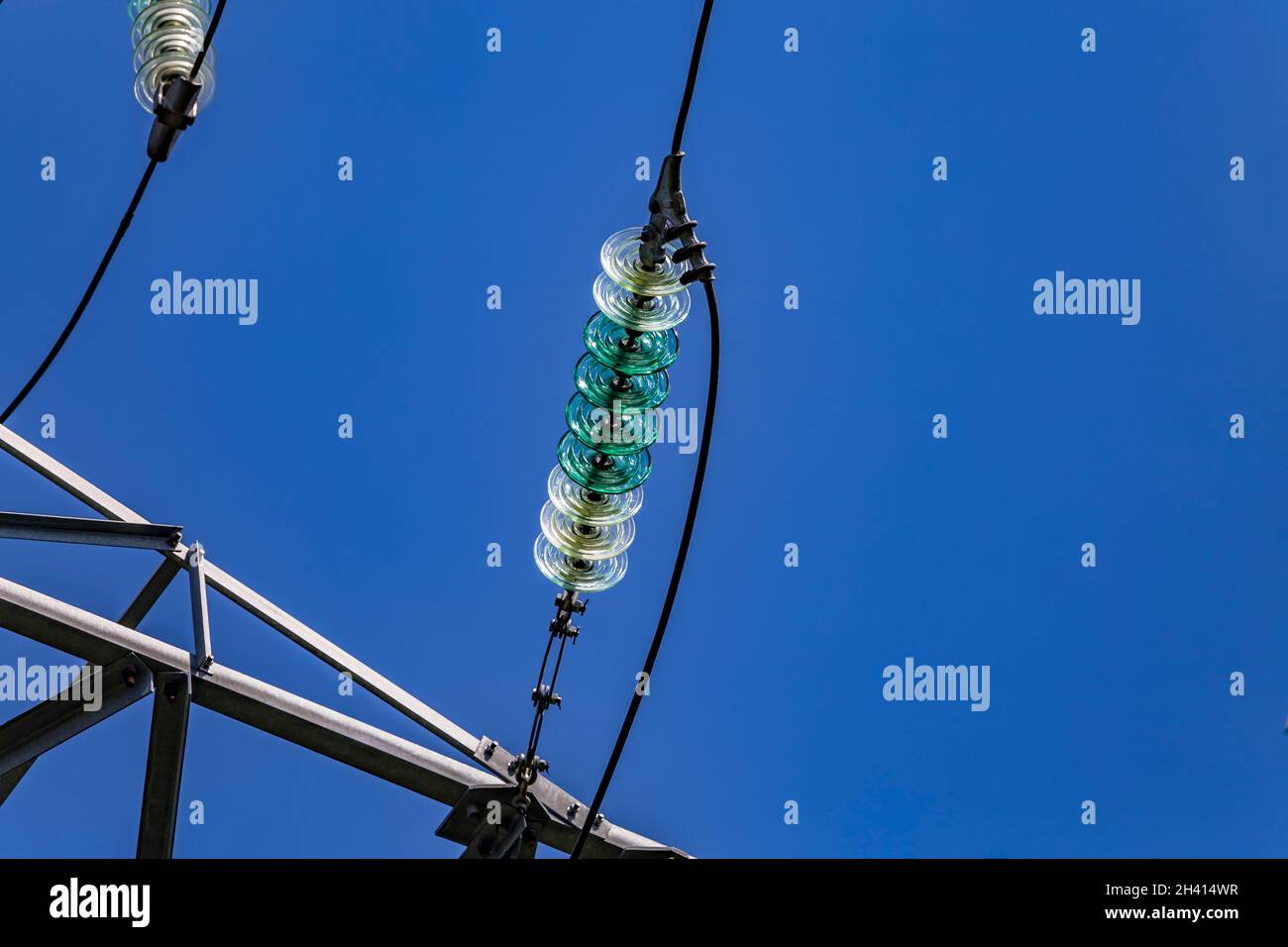 Close up of a transparent turquoise high voltage insulator or isolator ...