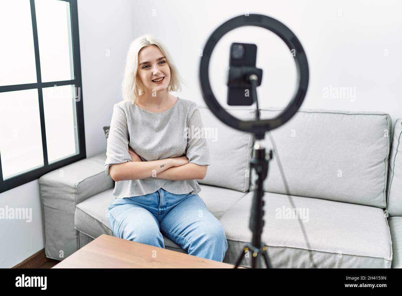 Young caucasian woman recording vlog tutorial with smartphone at home ...