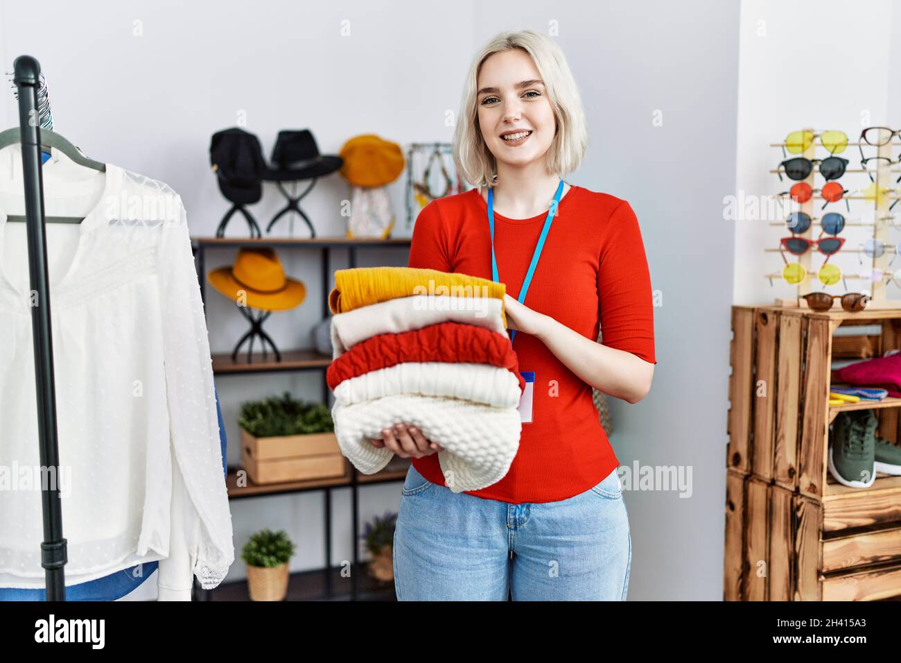 Young caucasian woman working as manager at retail boutique looking ...