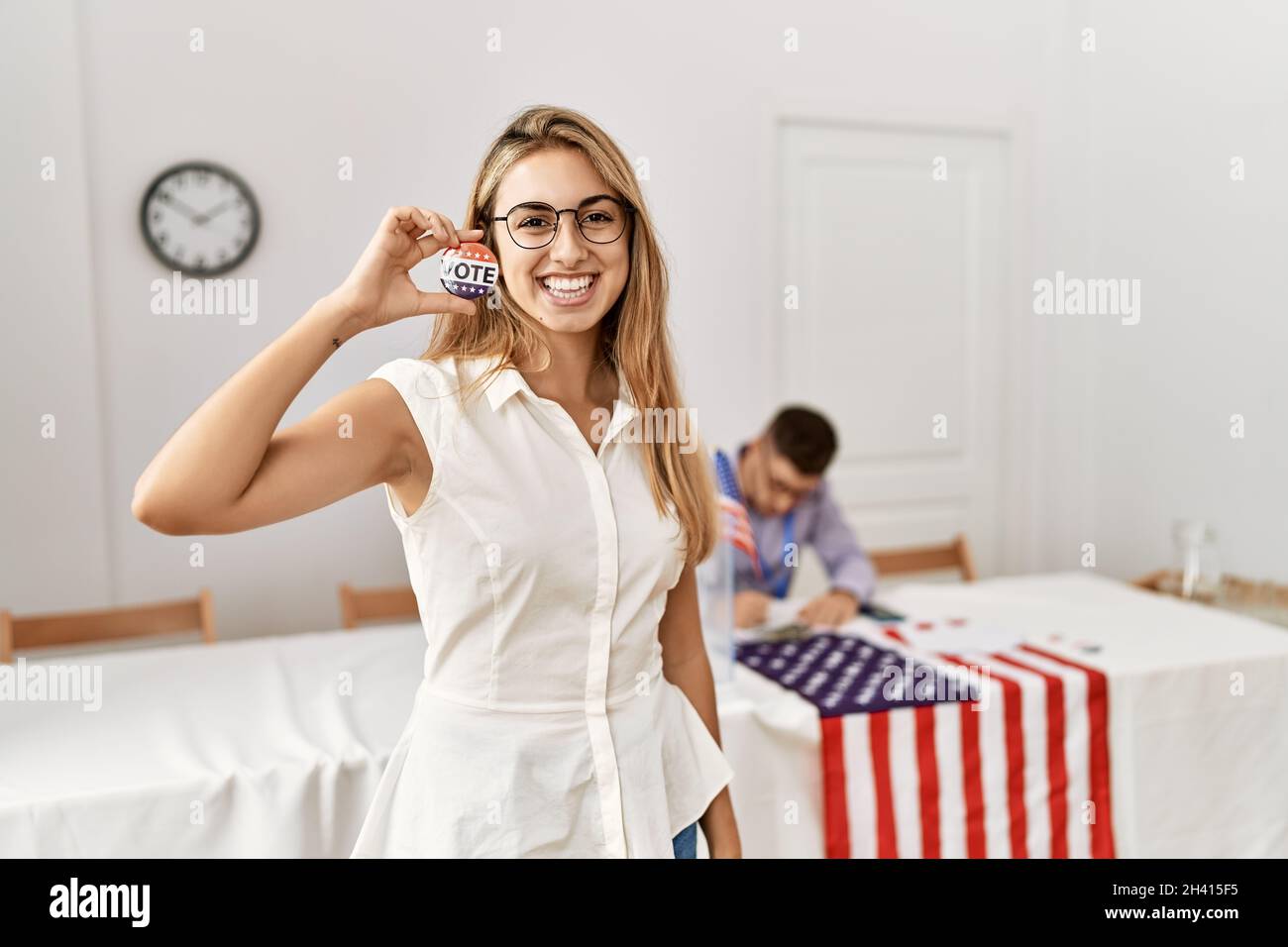Young american voter woman holding badge standing at electoral college ...