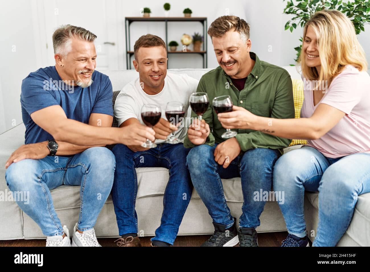Group of middle age friends toasting with glass of wine at home Stock ...