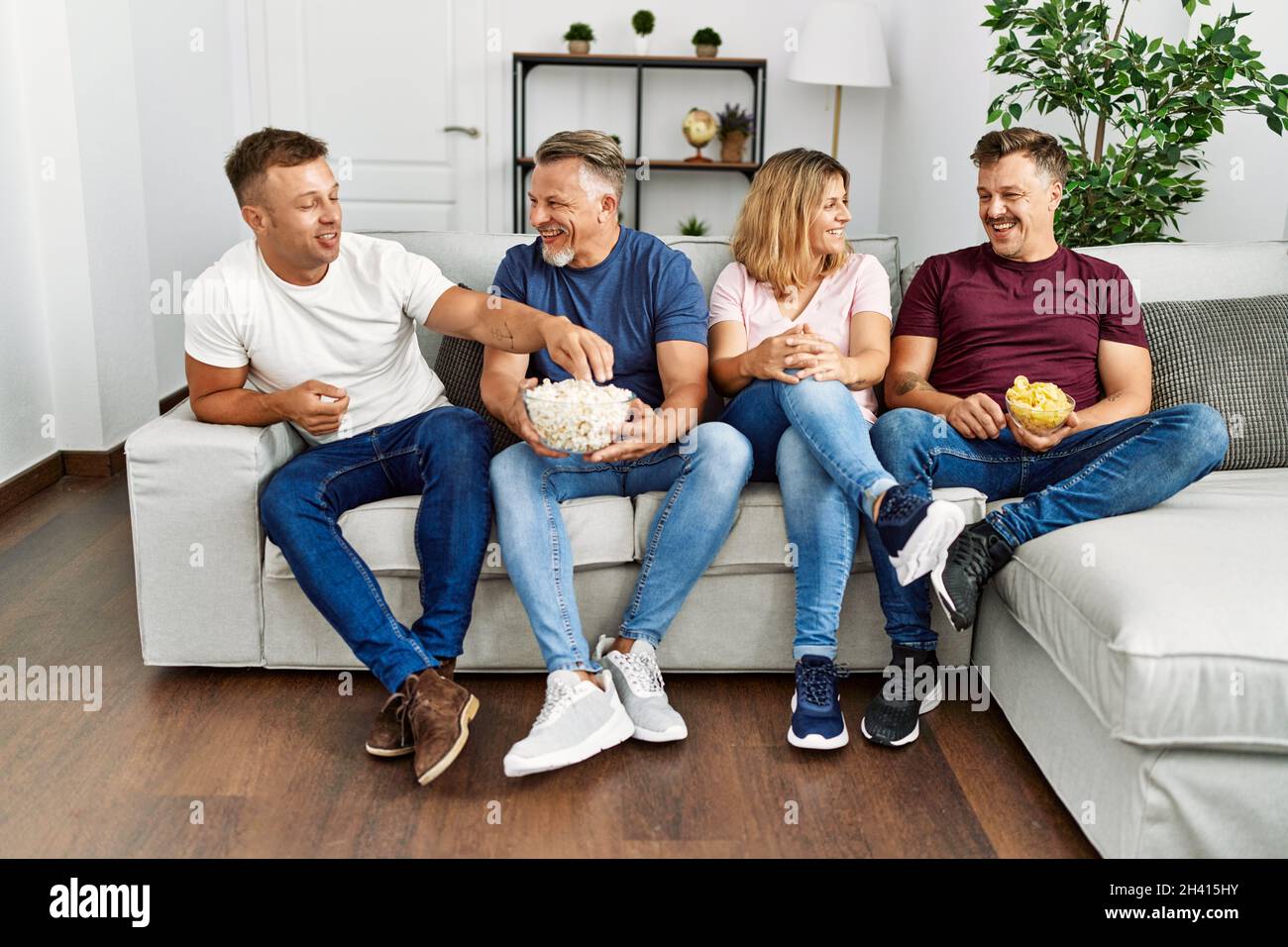 Group of middle age caucasian friends smiling happy watching movie at ...