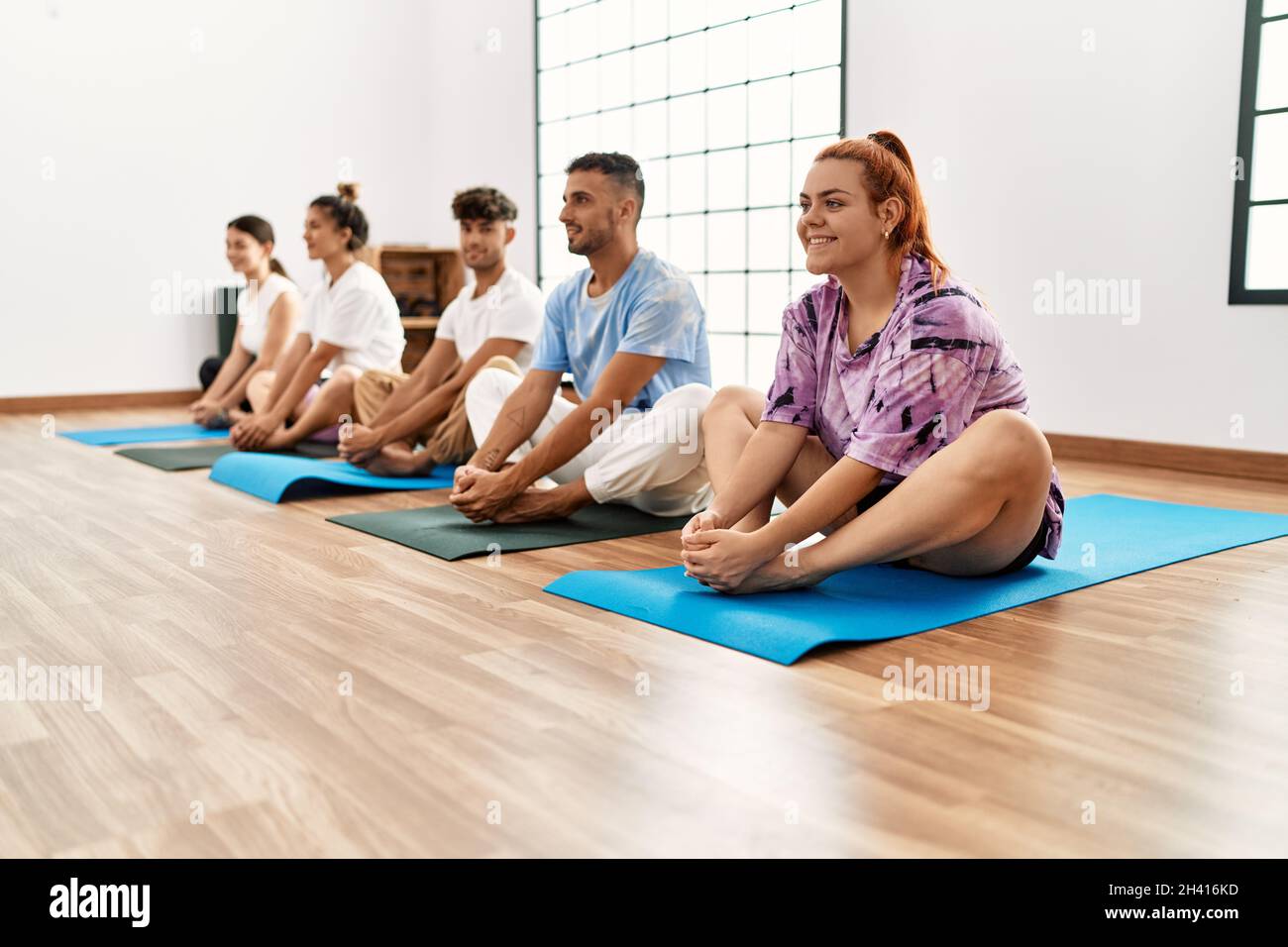 Group of young people smiling happy training yoga at sport center Stock ...