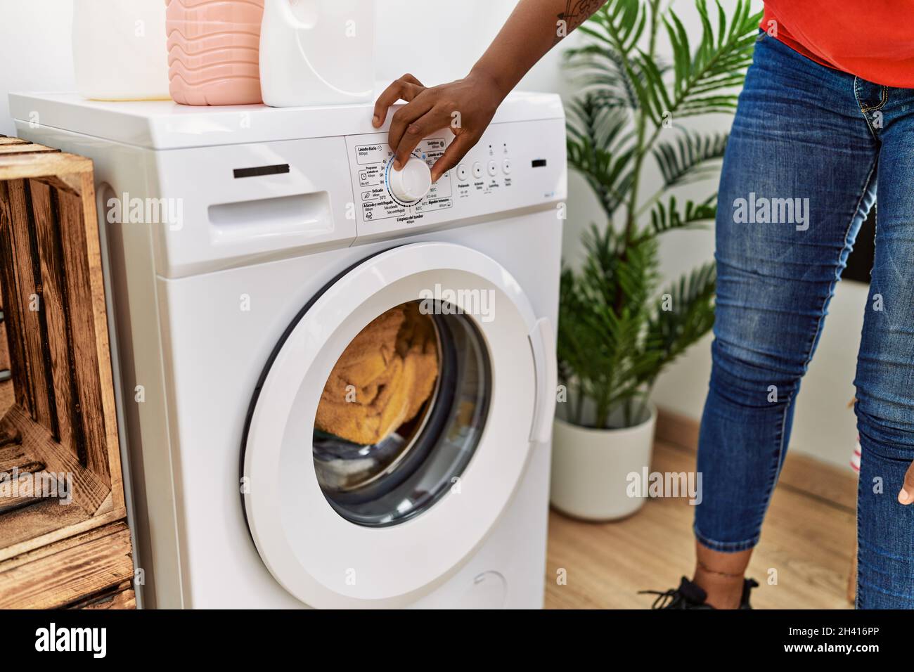Young african man setting washing machine at laundry room Stock Photo ...