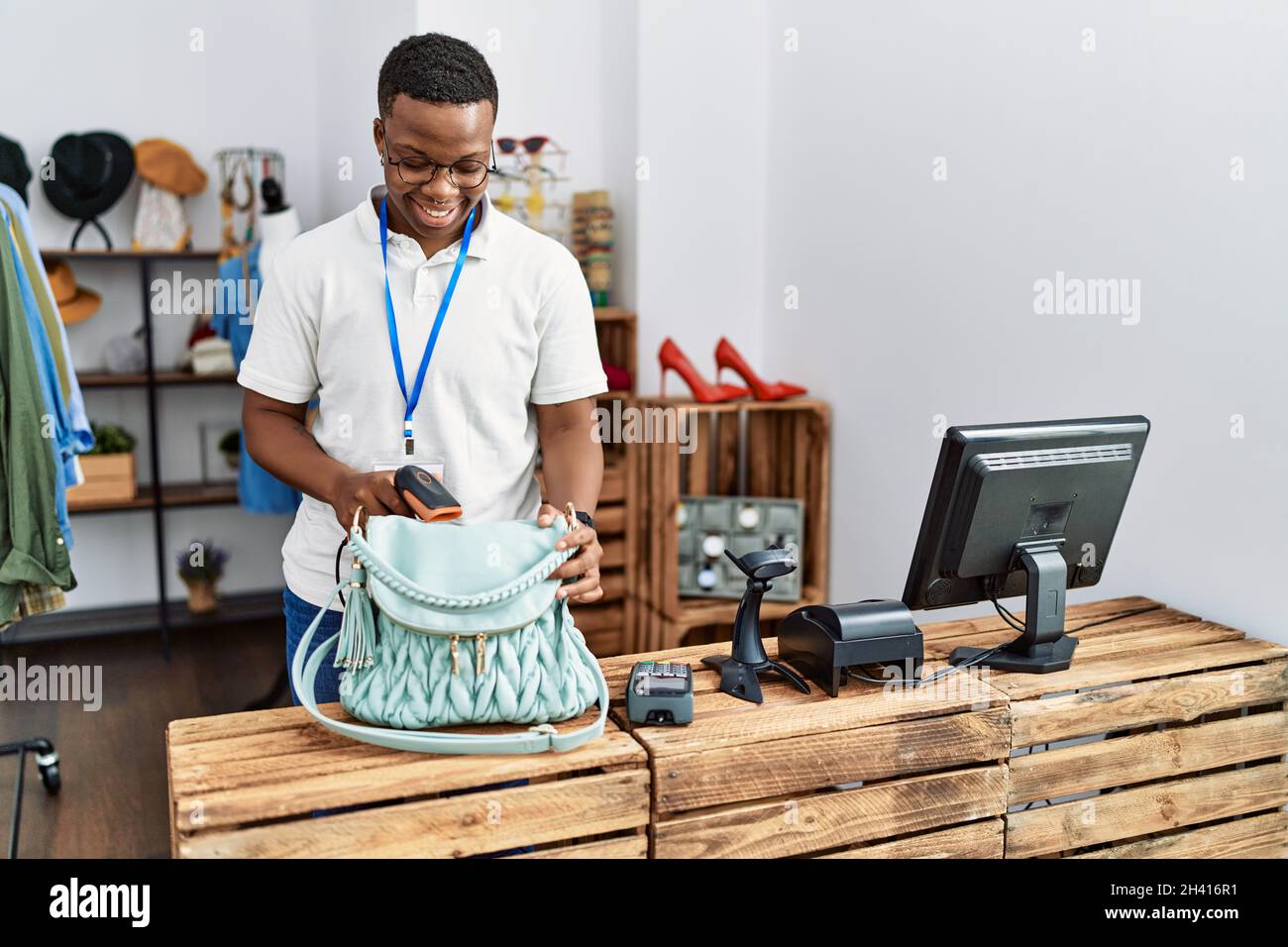 Young african man working as shop assistance at retail shop Stock Photo ...