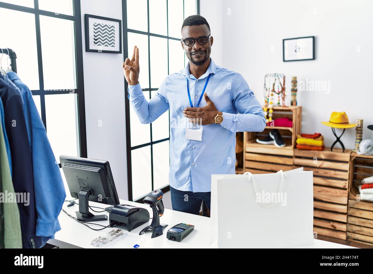 Young african man working as manager at retail boutique smiling ...
